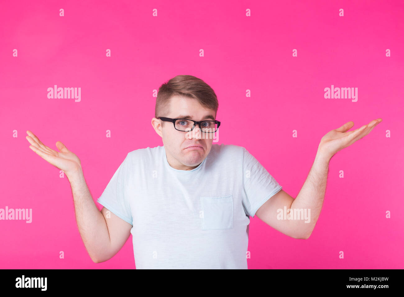 Doubtful caucasian man with gestures in uncertainty, confused and ...