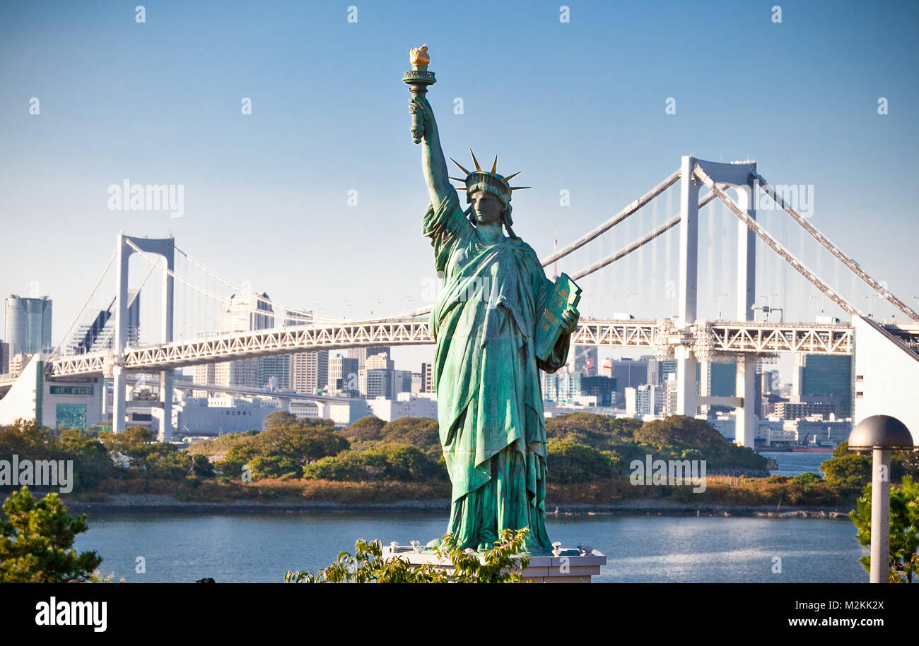 Lady liberty juxtaposed against Rainbow Bridge in Tokyo, Japan Stock ...