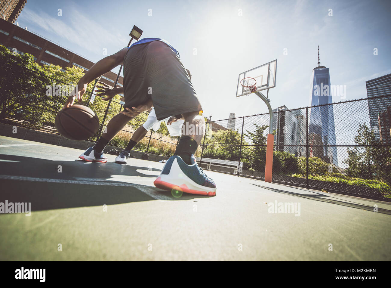 Two street basketball players playing hard on the court Stock Photo - Alamy