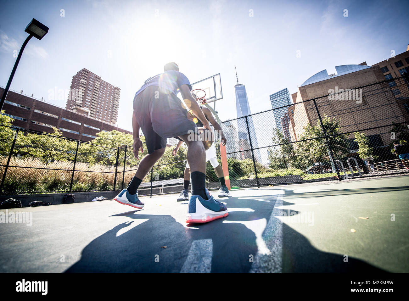 Two street basketball players playing hard on the court Stock Photo - Alamy