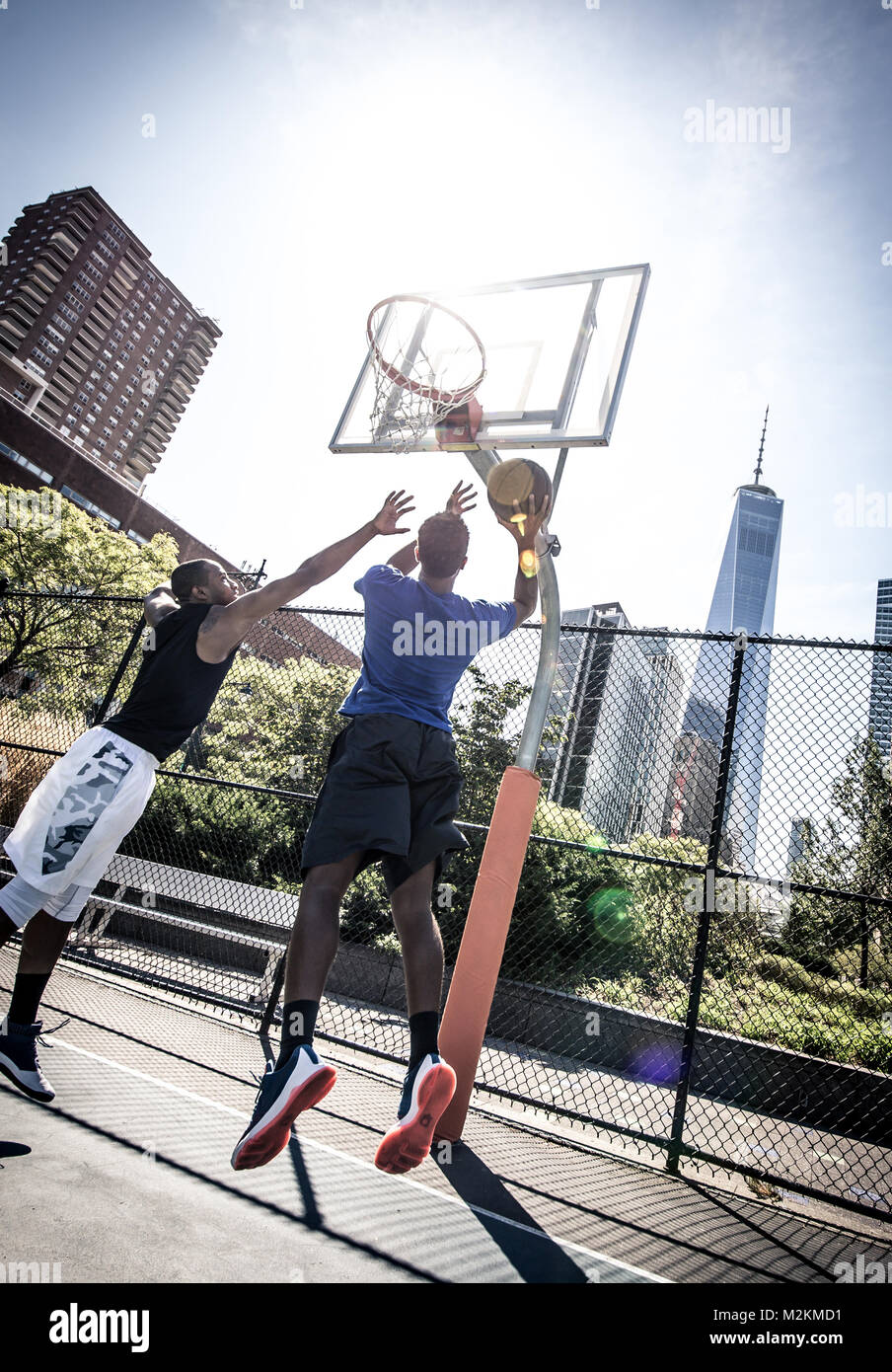 Two street basketball players playing hard on the court Stock Photo - Alamy