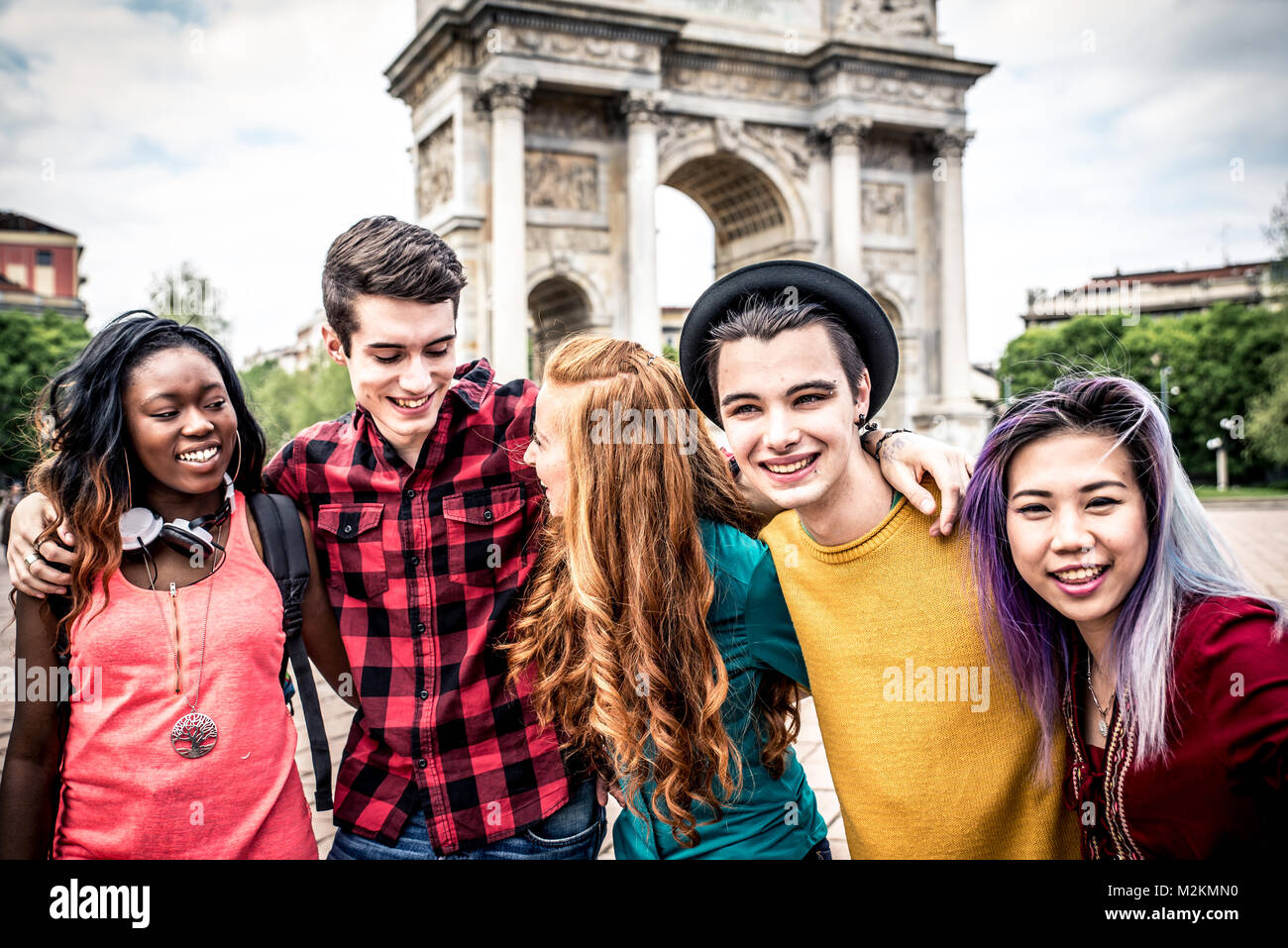 Multi-ethnic group of students studying together outdoors in a college ...