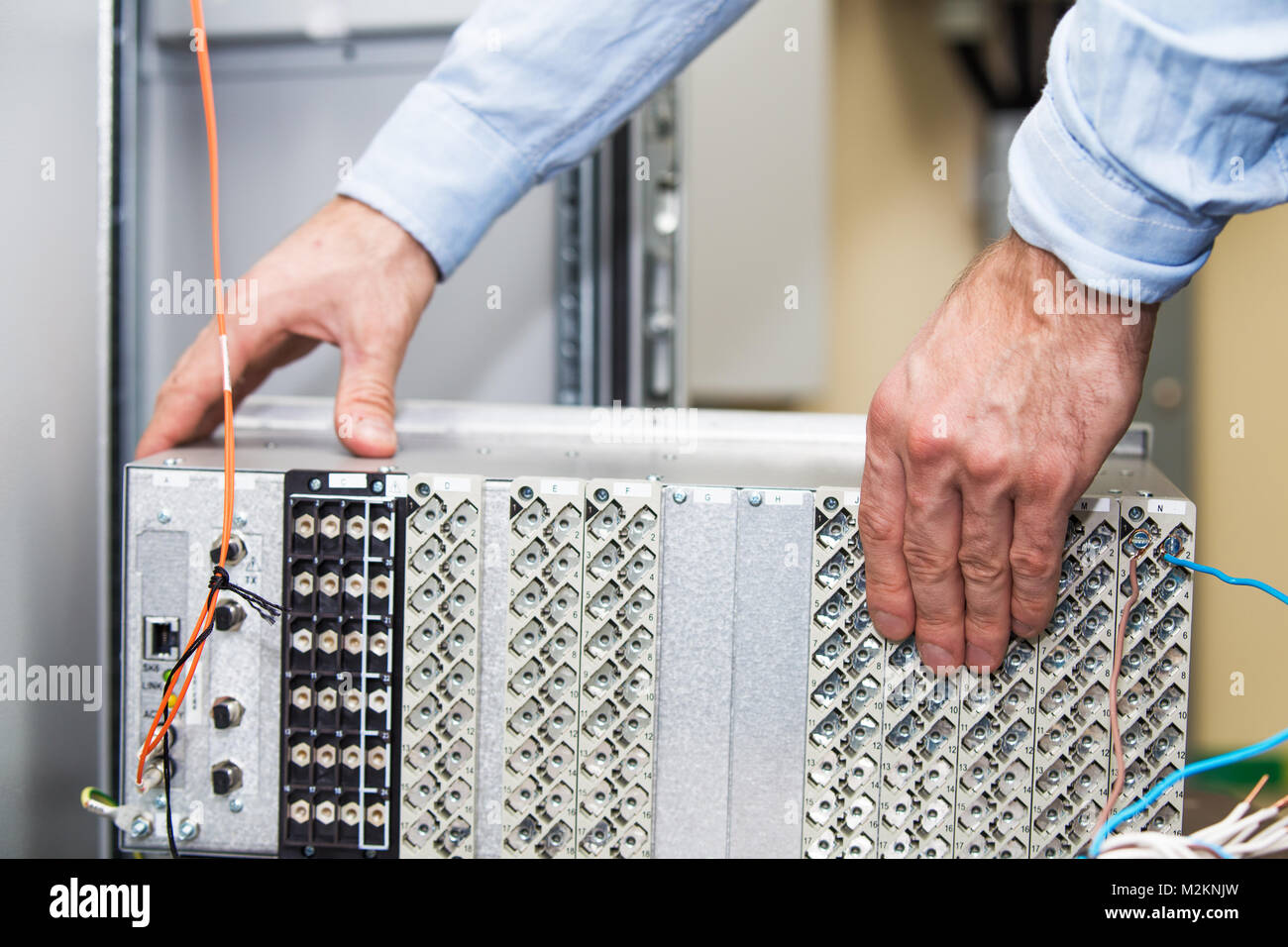 Hand of engineer on protection relay close-up. Instalation and tuning ...