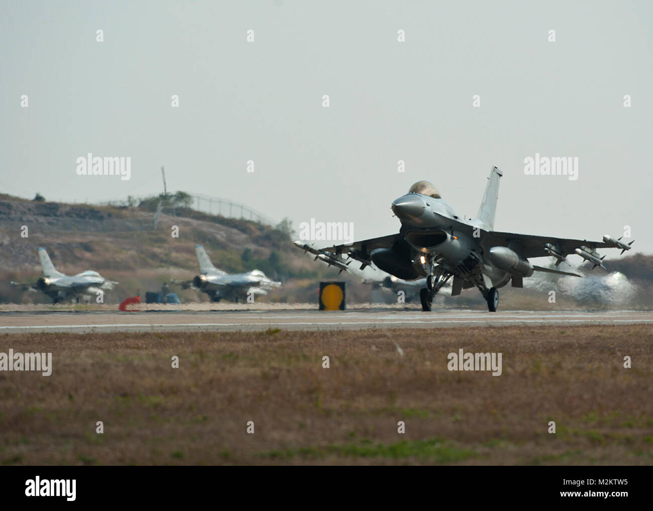 An F-16 Fighting Falcon with the 38th Fighter Group lands while other F ...