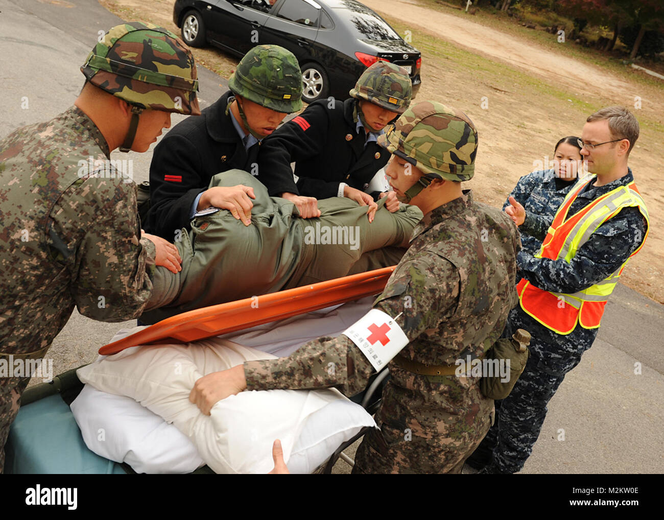 Members of the US and Republic of Korea Navy move a patient during ...