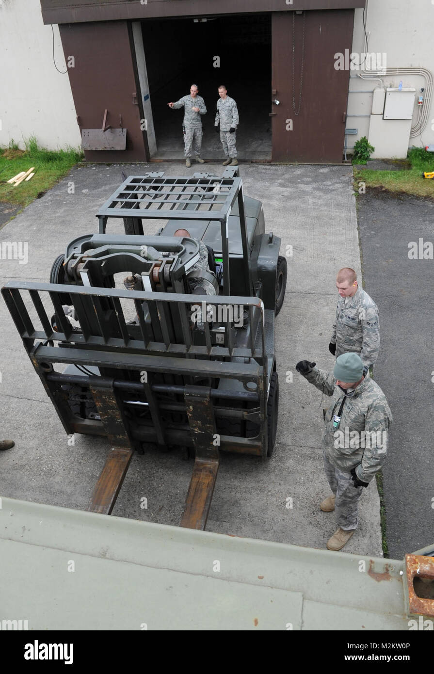 Members of the 86th Munitions Squadron load cargo trailers with ...