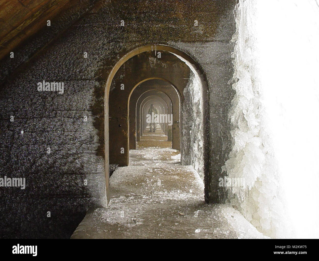 A lone Army engineer diver, framed by the arches of the Embrey Dam and ...
