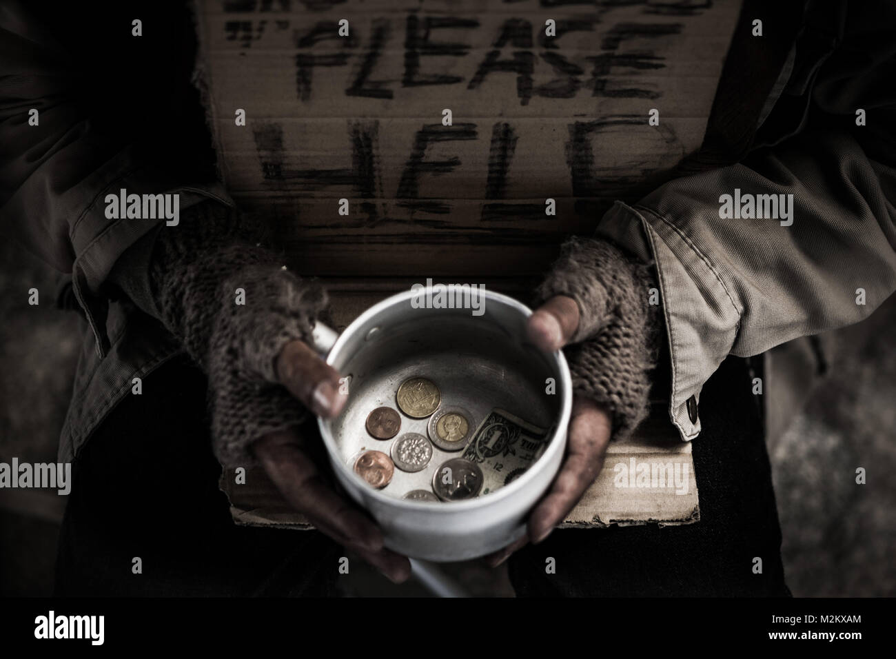 Homeless hands hold the bowl with money inside Stock Photo - Alamy