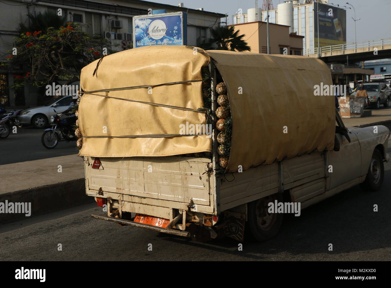 overloaded cars mostly with goods to sell at the market like pineapples ...