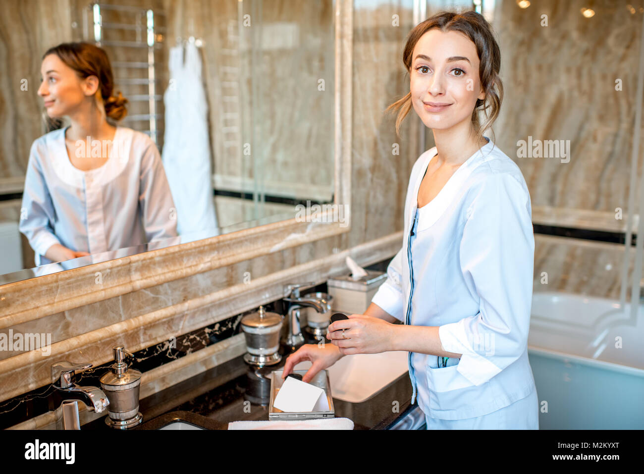Young chambermaid cleaning hotel hi-res stock photography and images ...