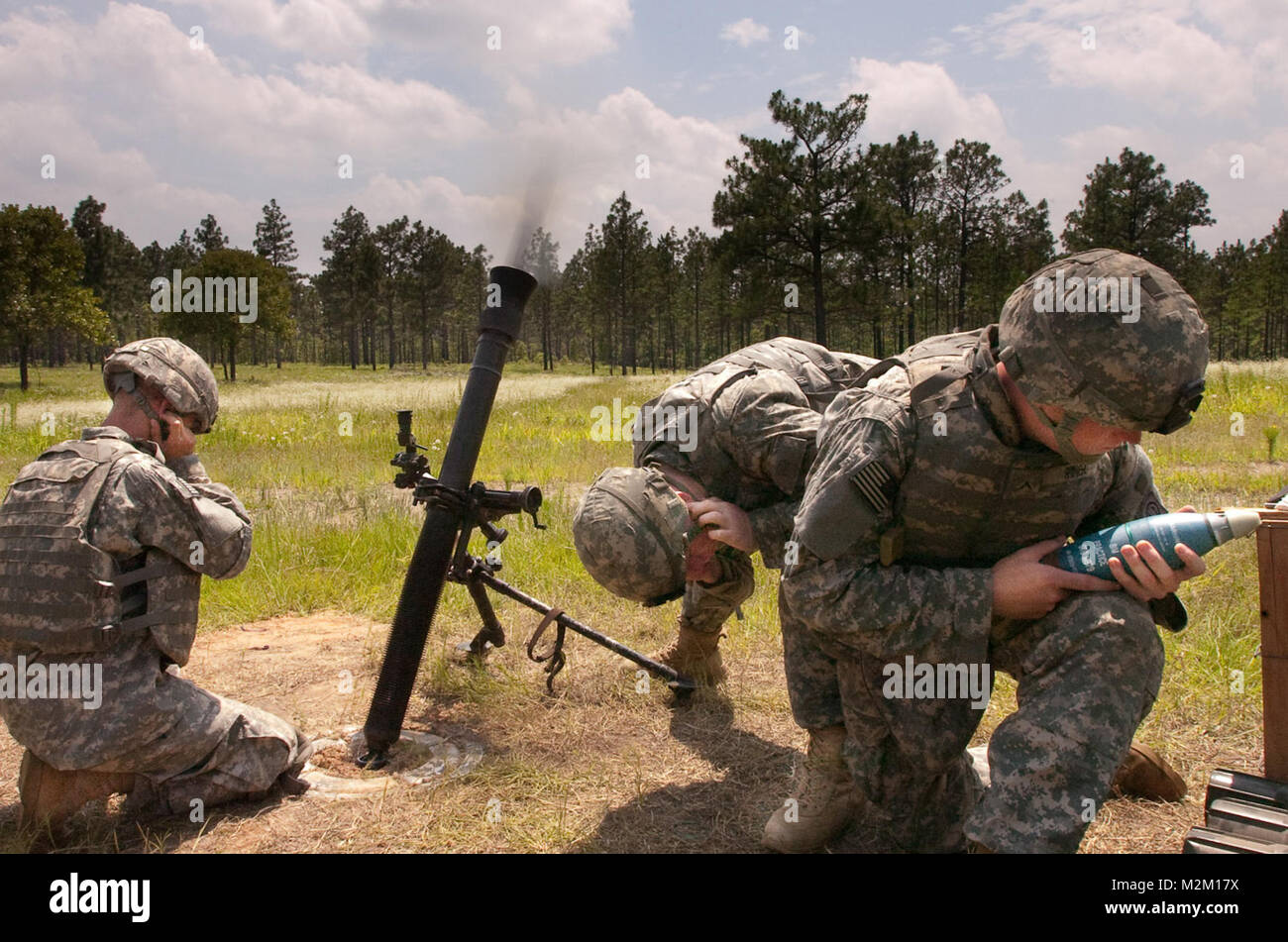 A mortar crew with Mortar Platoon, Headquarters and Headquarters ...