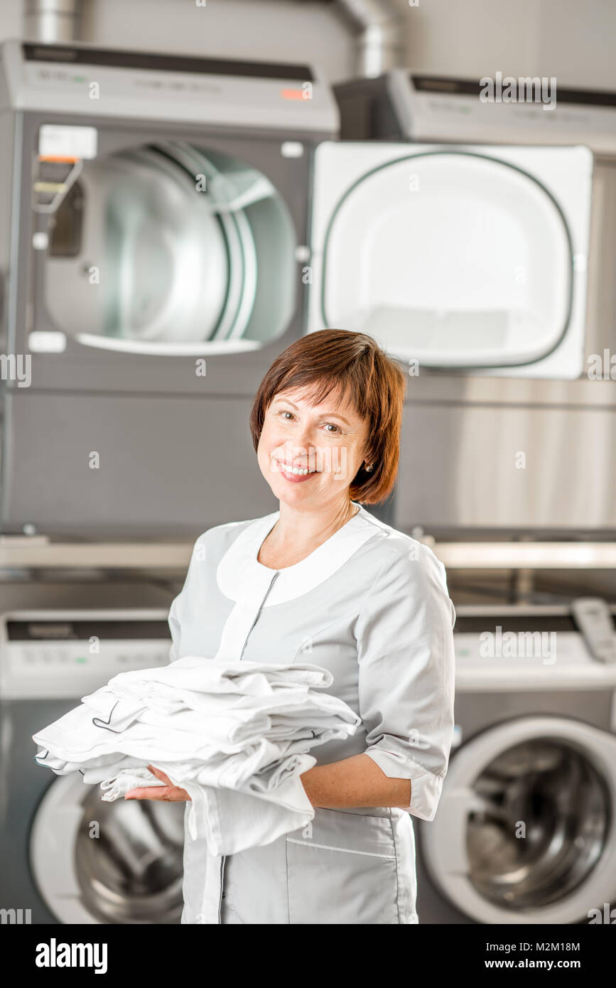 Senior washwoman in the laundry Stock Photo - Alamy