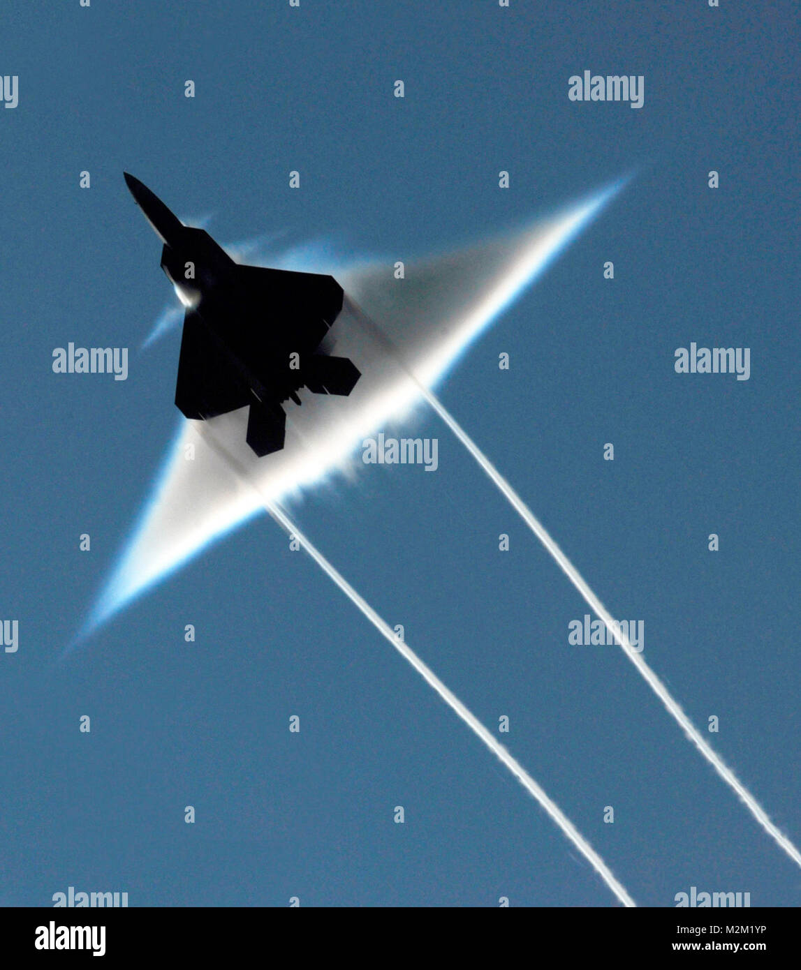 An Air Force F-22 Raptor executes a supersonic flyby over the flight ...