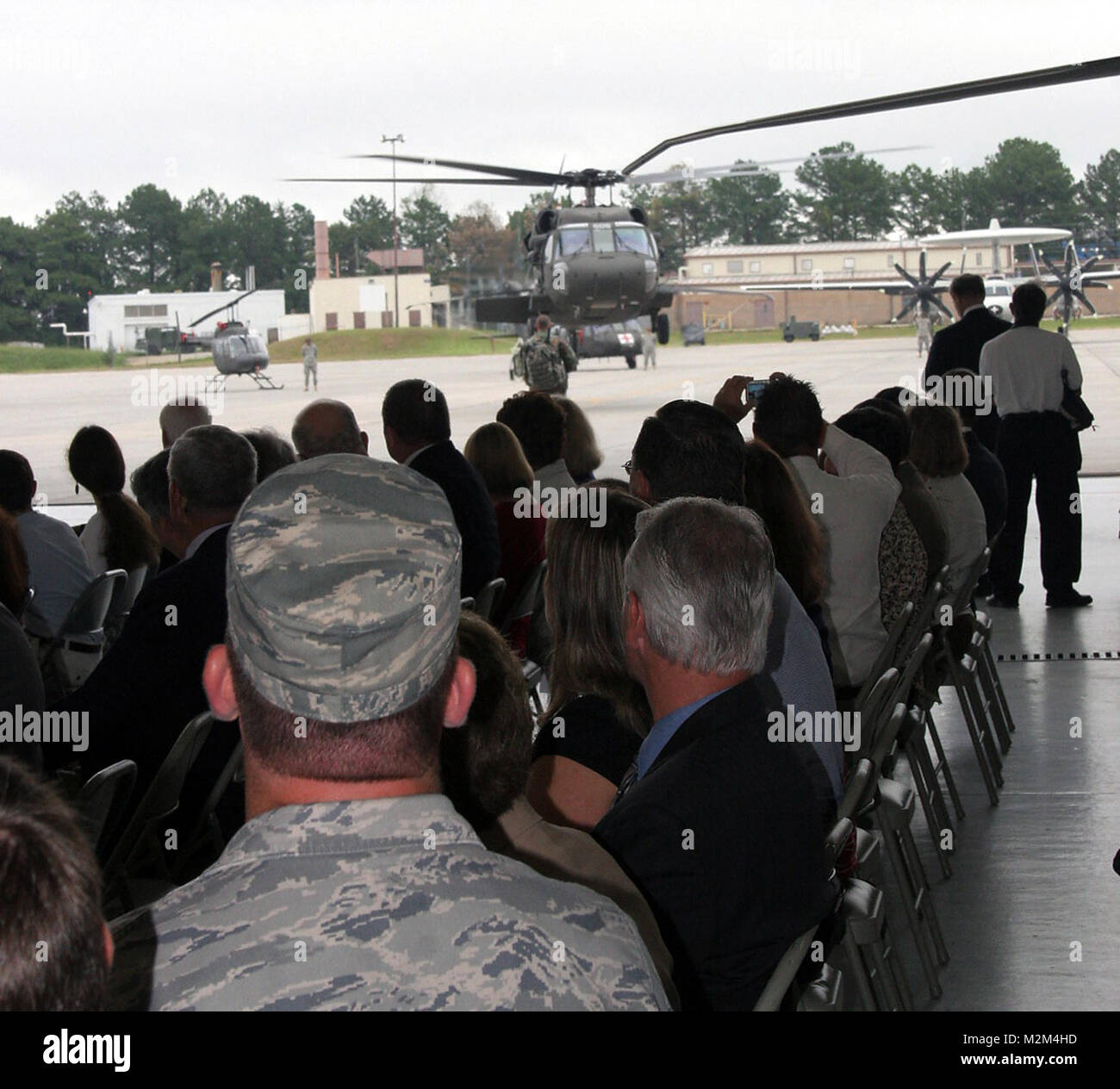 A UH-60 Blackhawk helicopter hovers outside the hanger where the ...