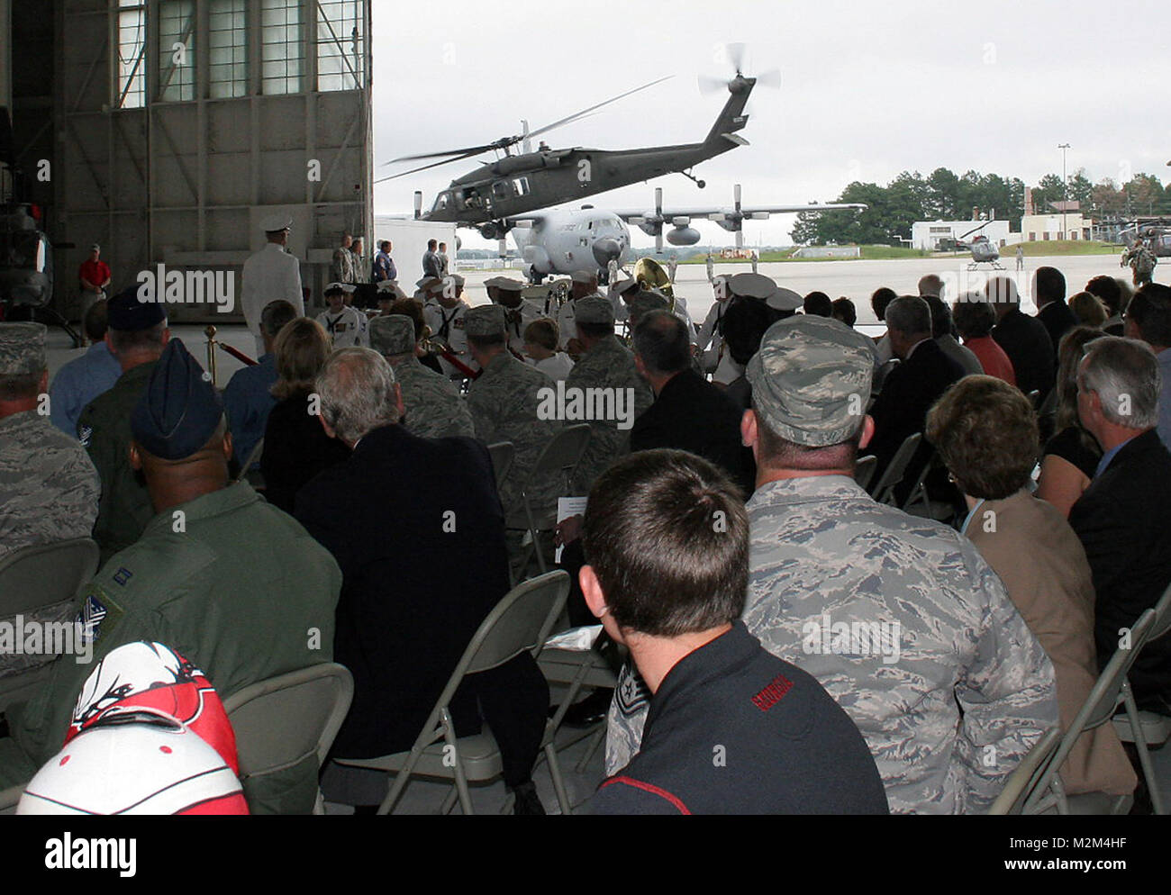 A UH-60 Blackhawk helicopter hovers outside the hanger where the ...