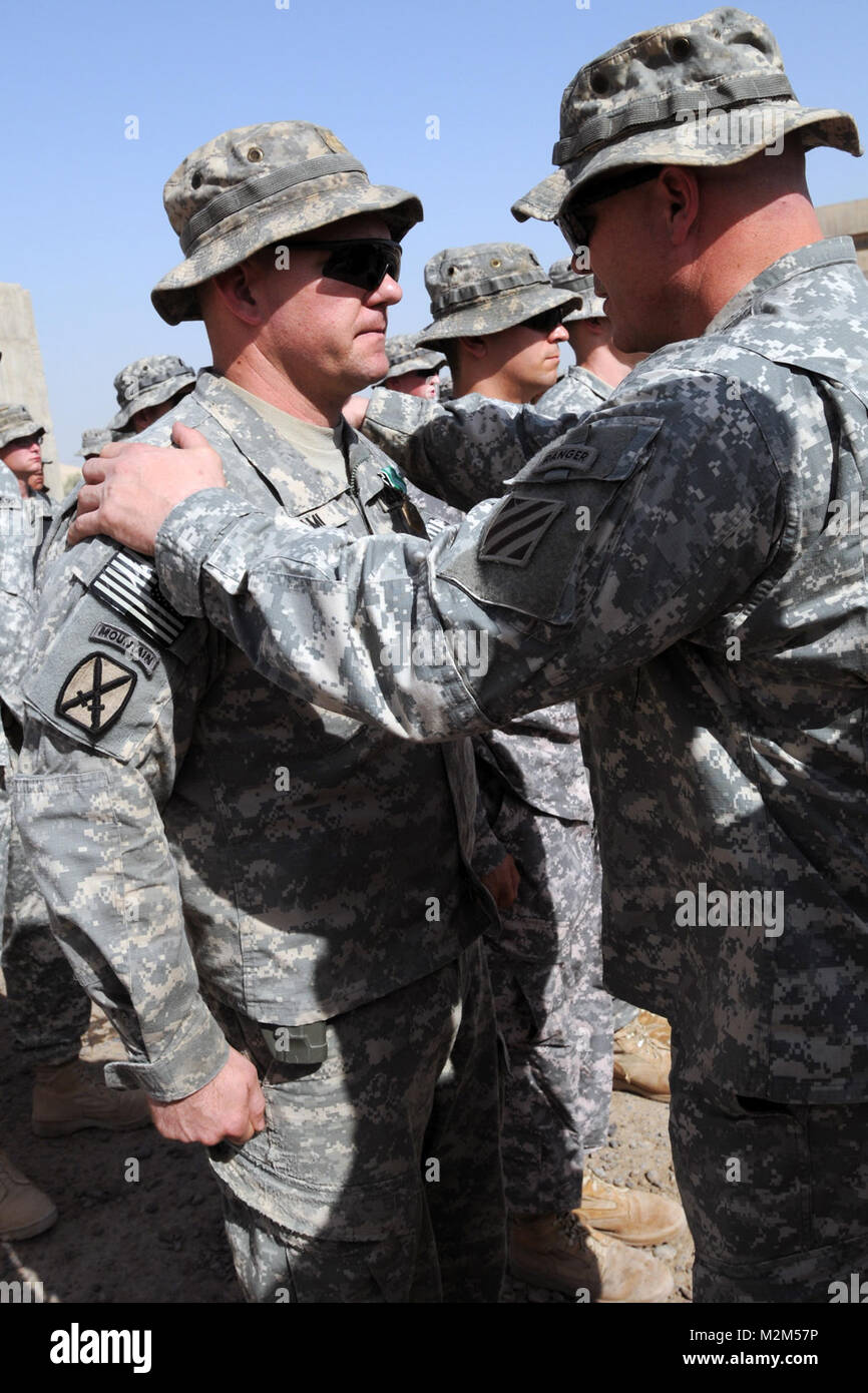Receiving an Army Commendation Medal by 1st Armored Division and Fort ...