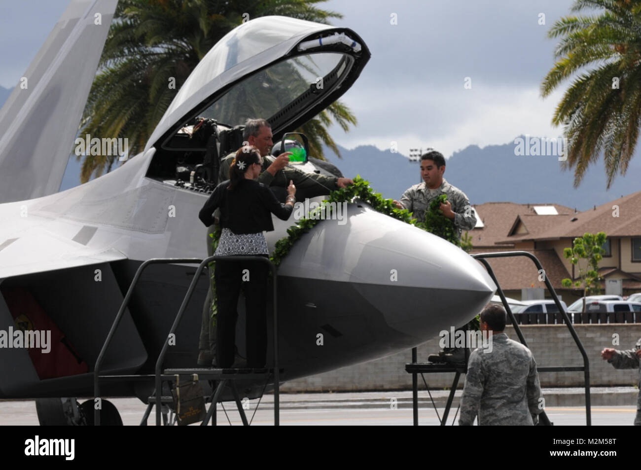 Lt Col Christopher Faurot, his spouse and SSgt Ben Nitta drape the ...