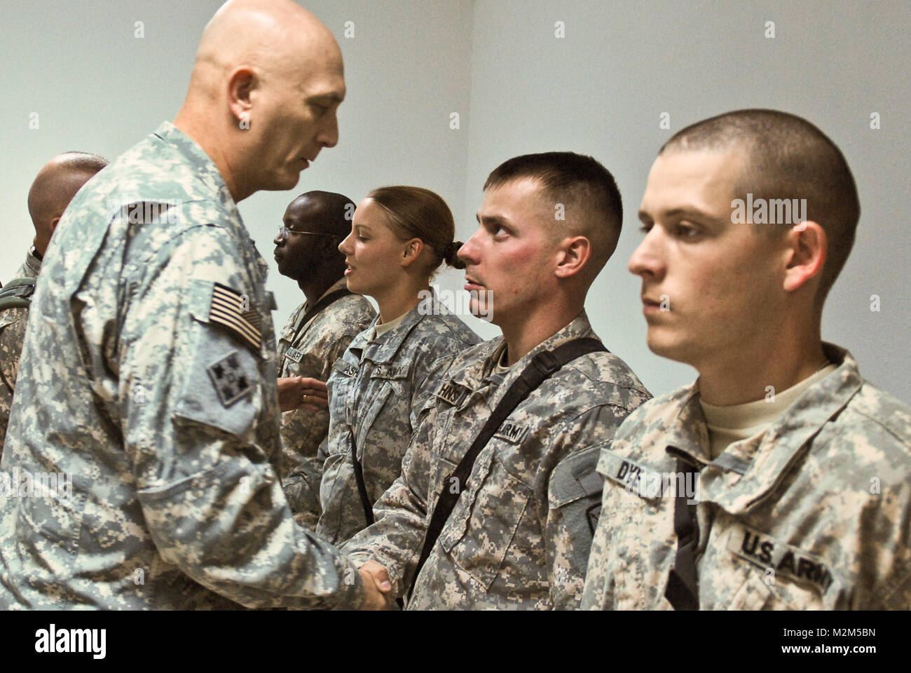 Gen. Raymond Odierno presents Staff Sgt. Johnson his coin. Staff Sgt ...