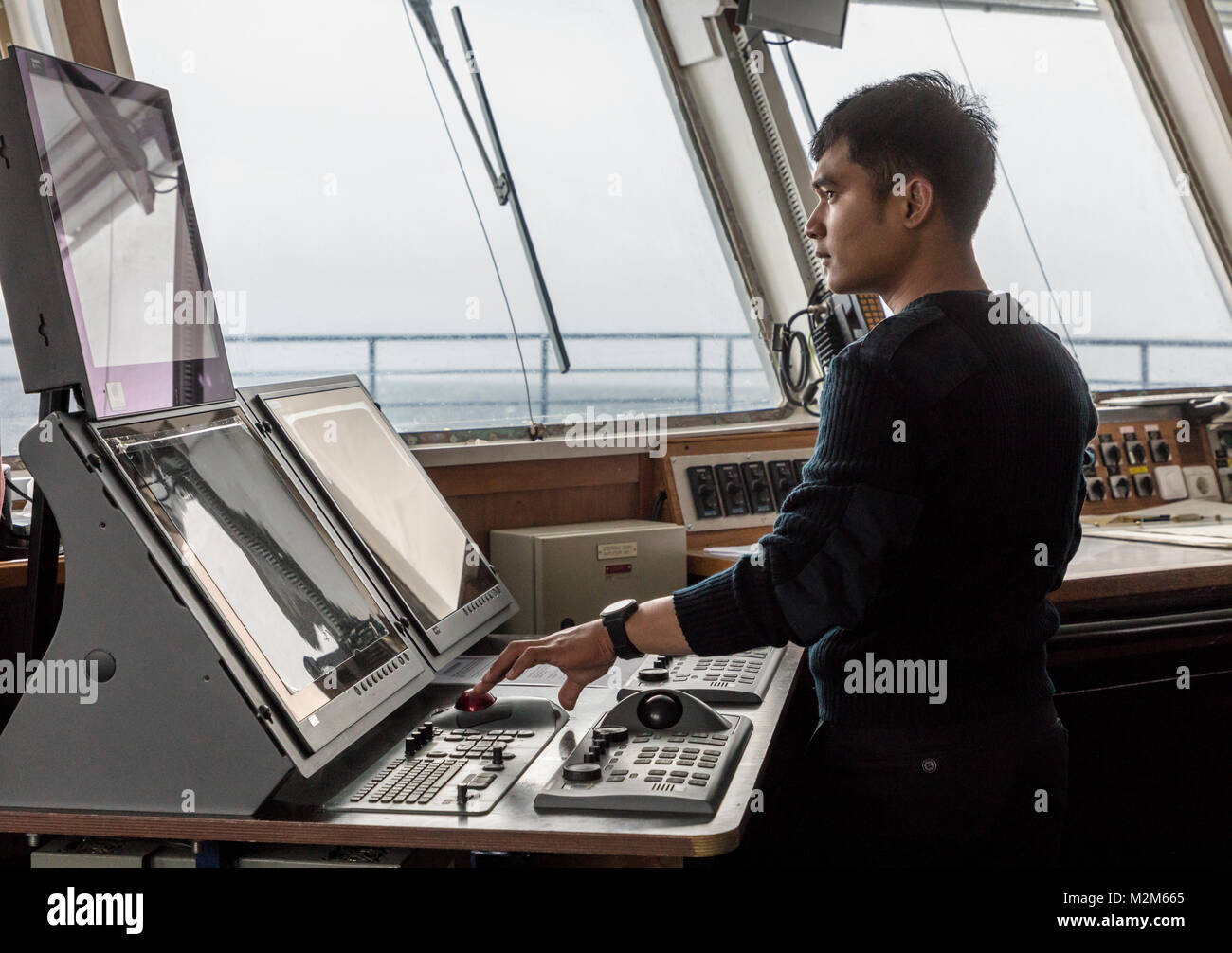 Ship's crew on bridge sailing passenger ship Ocean Adventurer; carries ...