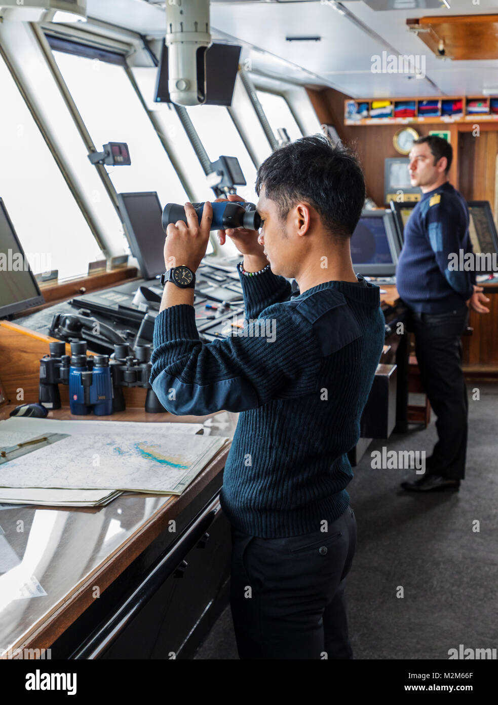 Ship's crew on bridge sailing passenger ship Ocean Adventurer; carries ...