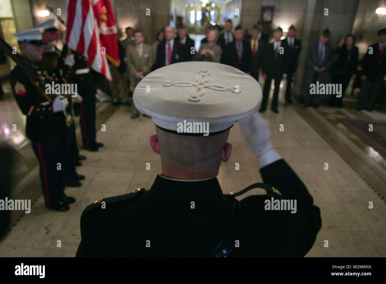 A Marine salutes the color guard during a Veterans Day ceremony, in the ...