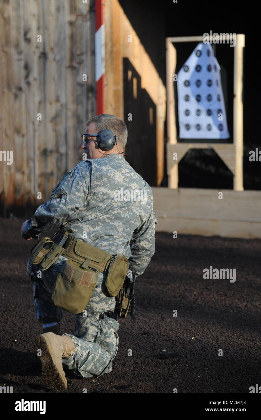 A U.S. soldier reloads his M9 during a joint weapons training exercise ...