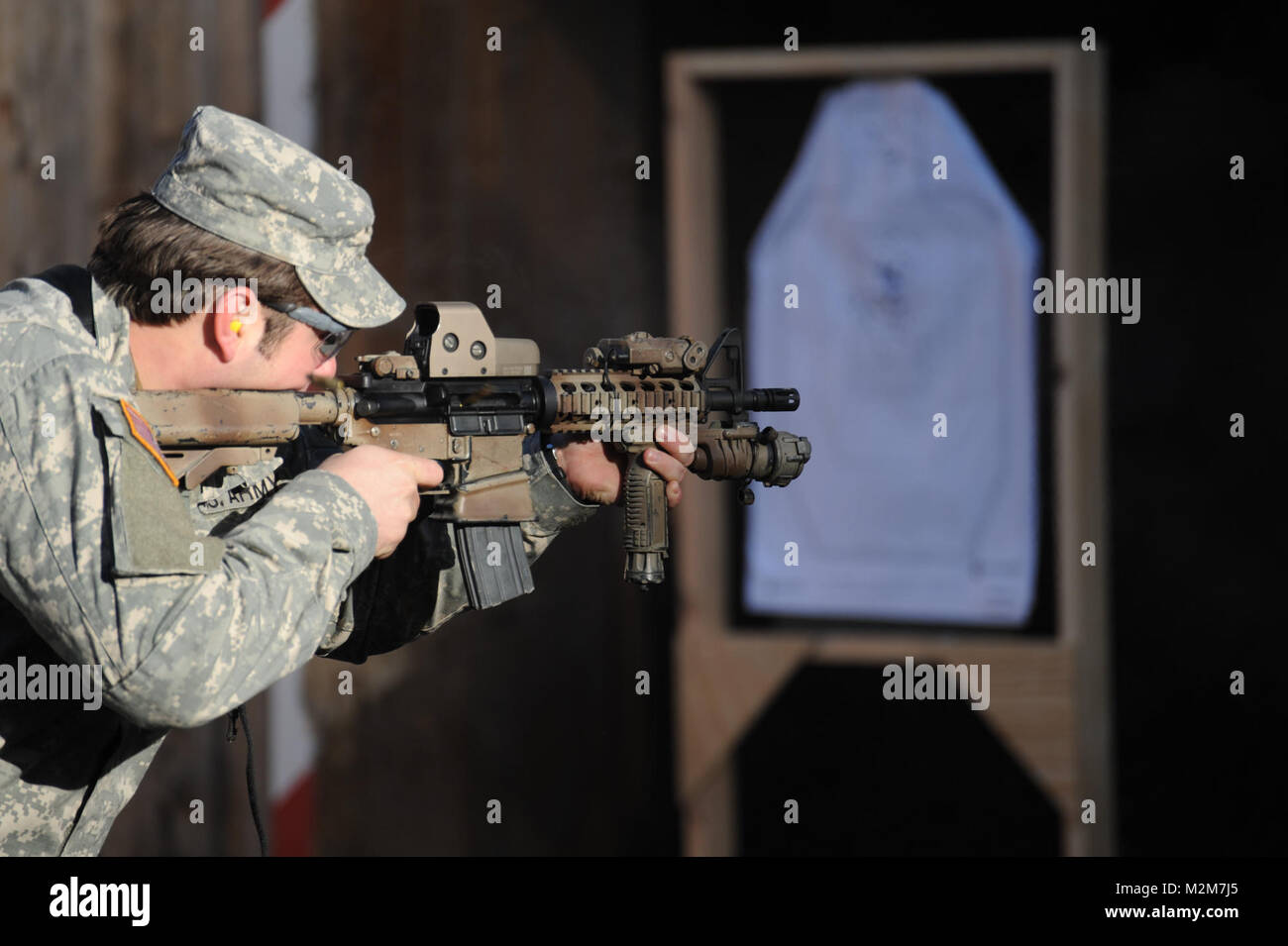 A U.S. soldier fires his m-4 during a joint weapons training exercise ...
