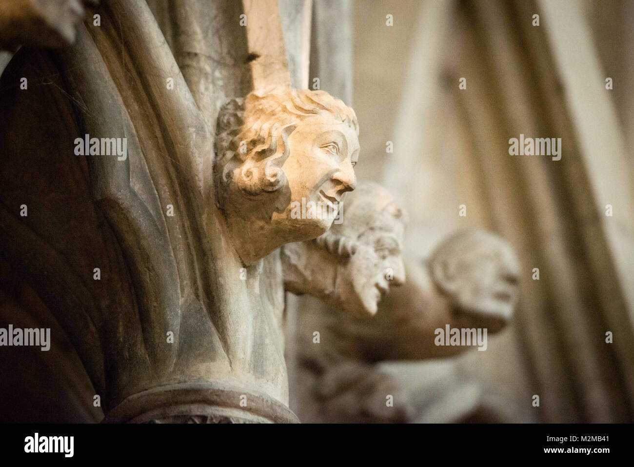Statues of human face protruding from the wall of the York Minster ...