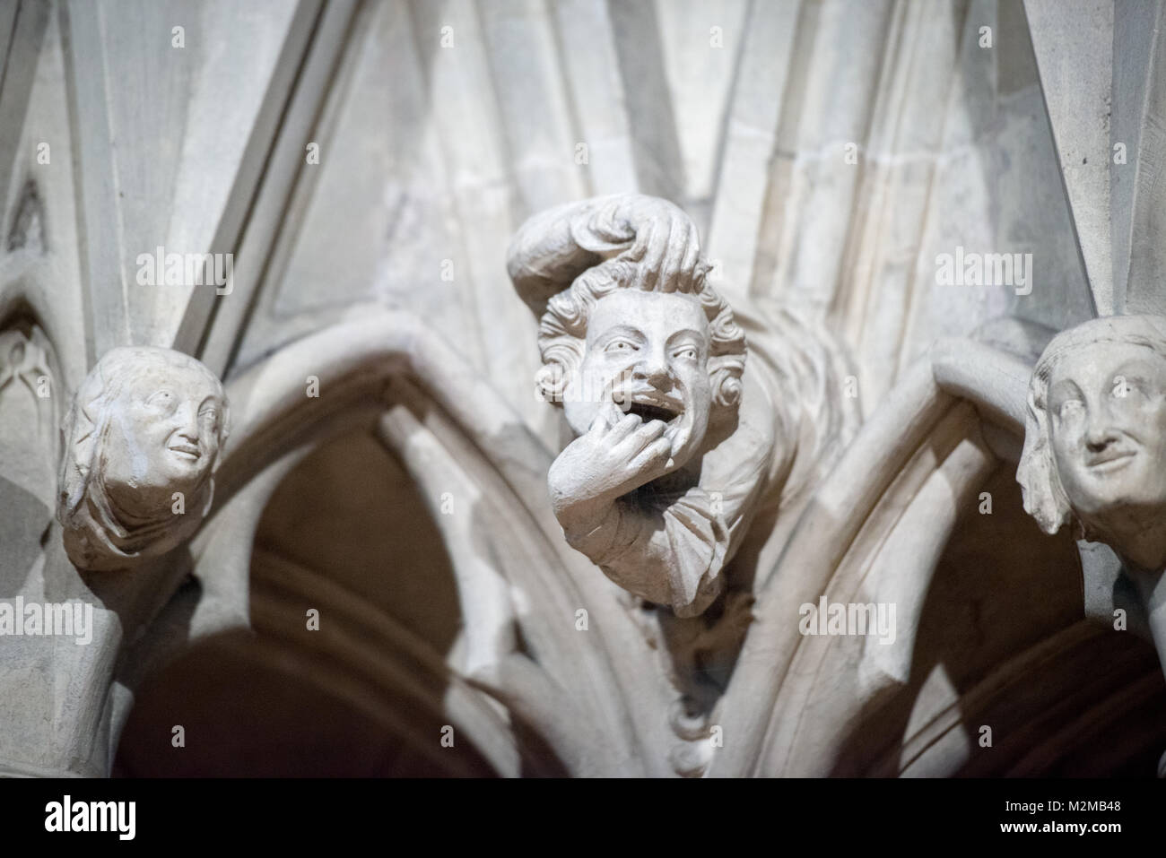 Humorous statue of a human face pulling its face open with its hands ...