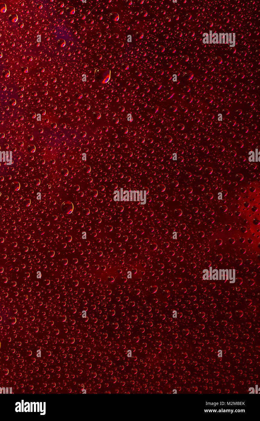 Red background of a rainbow of water droplets Stock Photo - Alamy