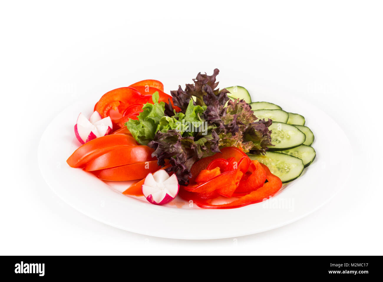 Sliced vegetables on a plate. Isolated on a white background Stock ...