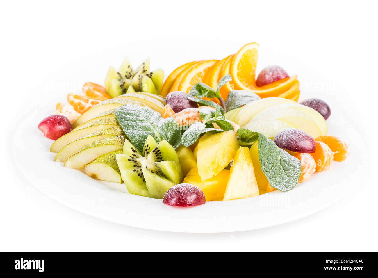 Fruit plate, isolated. apple, mandarin, kiwi, grapes, mint, pear, apple ...