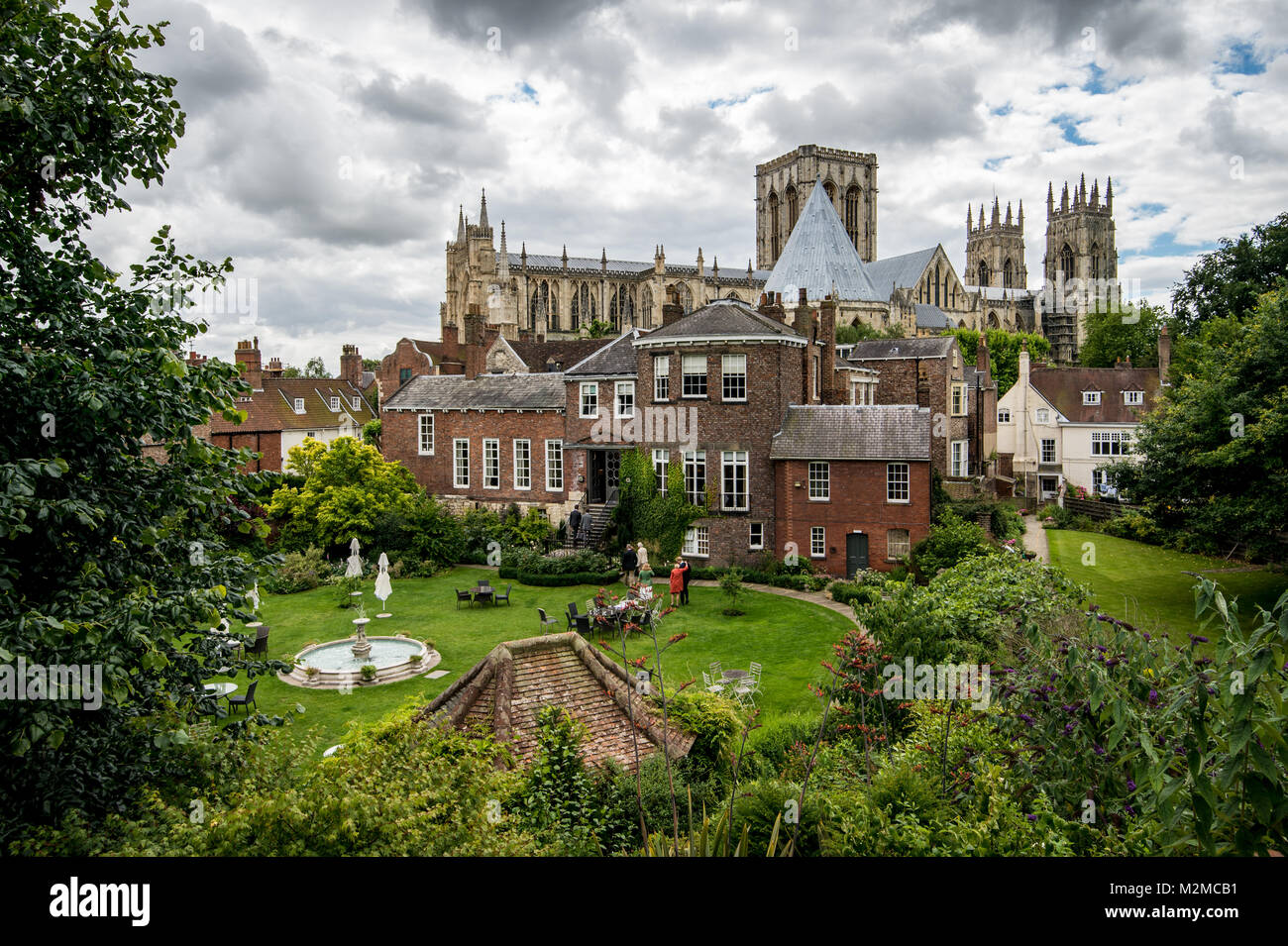 Dramatic clouds loom over the picturesque backyard garden with York ...