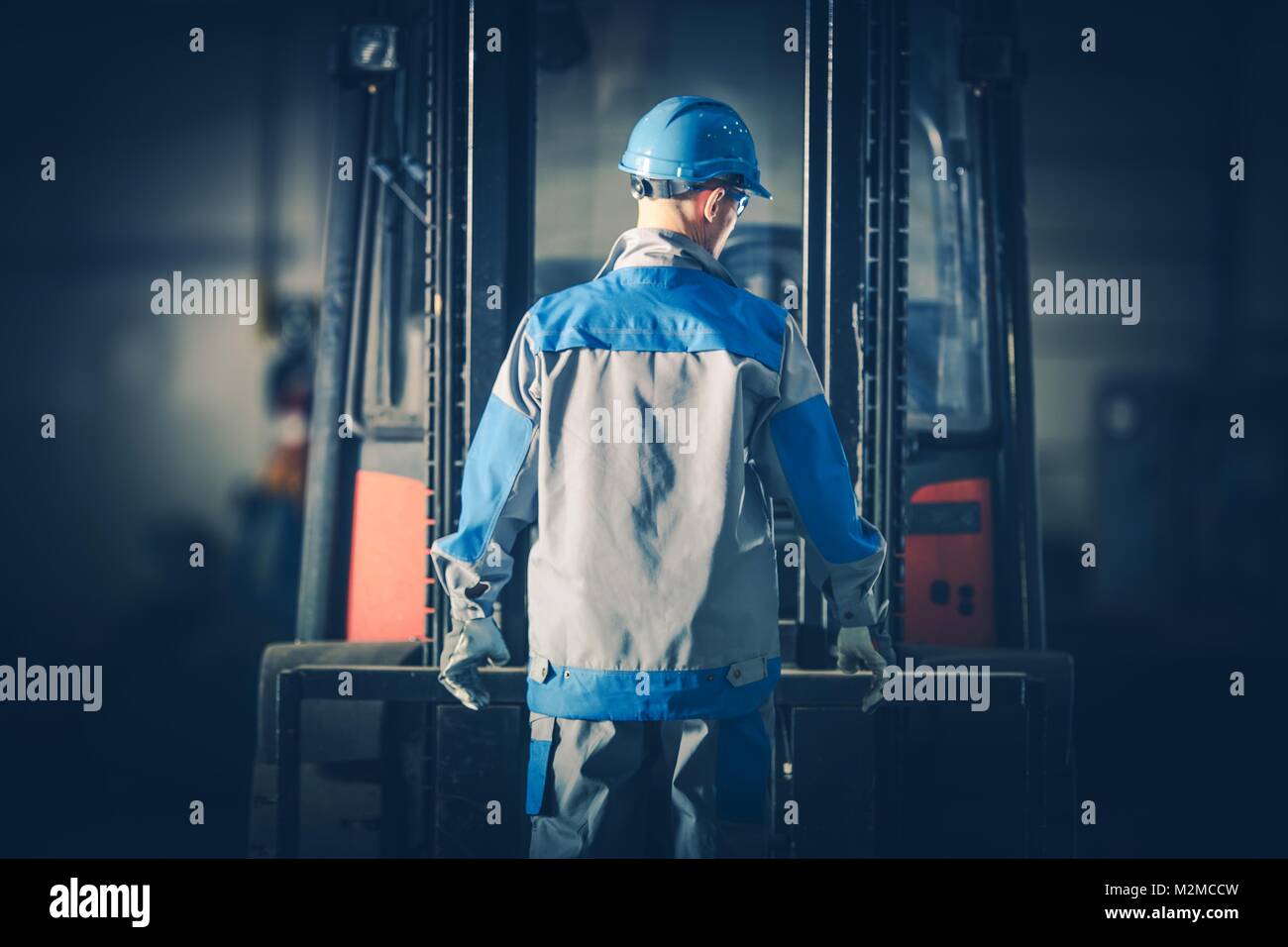 Caucasian Warehouse Forklift Operator in Front of His Lift Truck ...