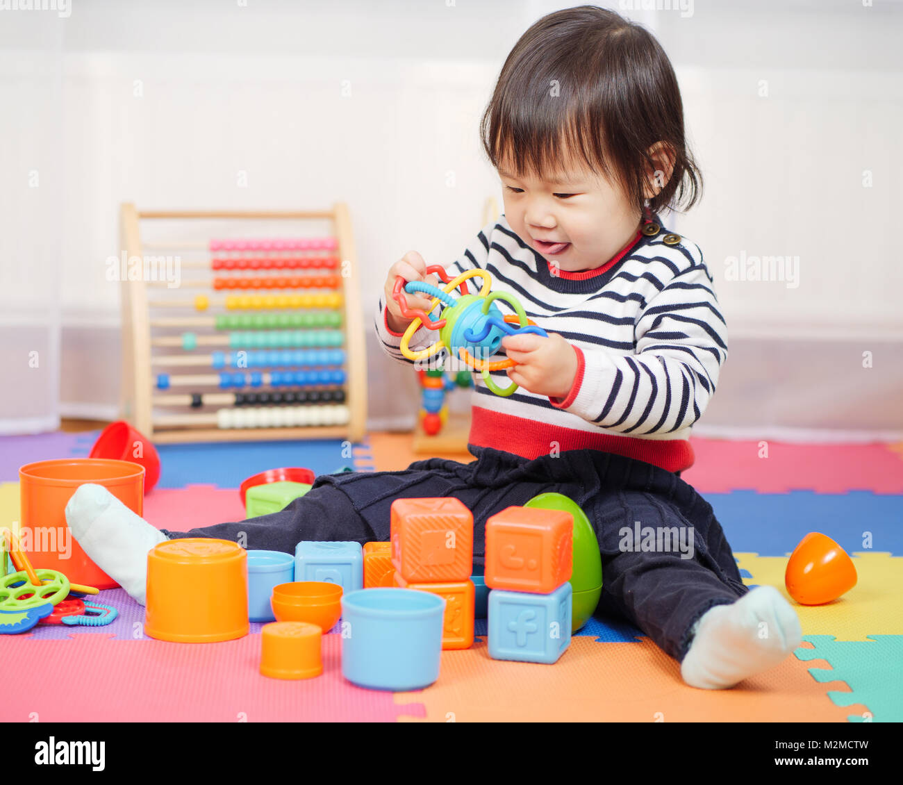 baby girl play toy at home Stock Photo - Alamy