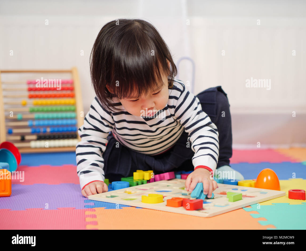 baby girl learning alphabet at home Stock Photo - Alamy