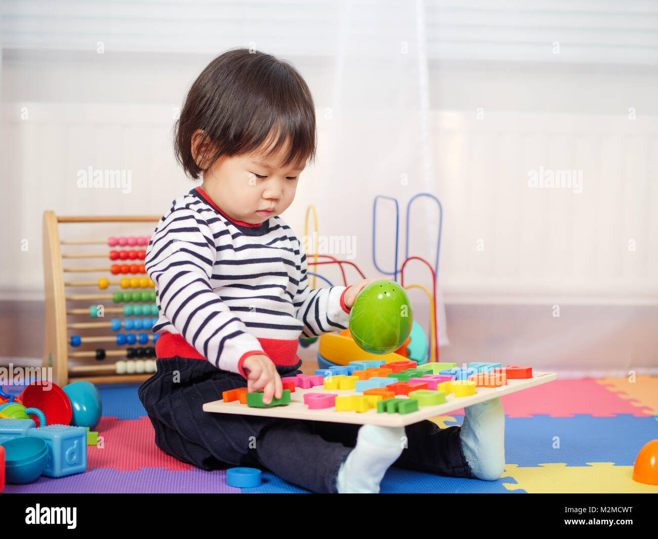baby girl learning alphabet at home Stock Photo - Alamy