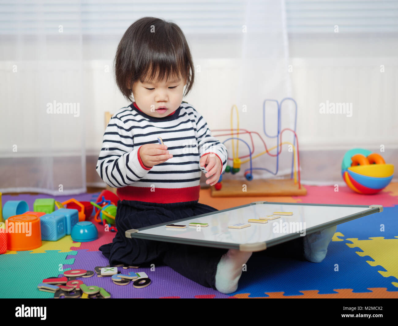 Baby girl learning math at home Stock Photo - Alamy