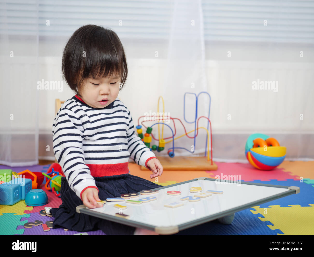 Baby girl learning math at home Stock Photo - Alamy