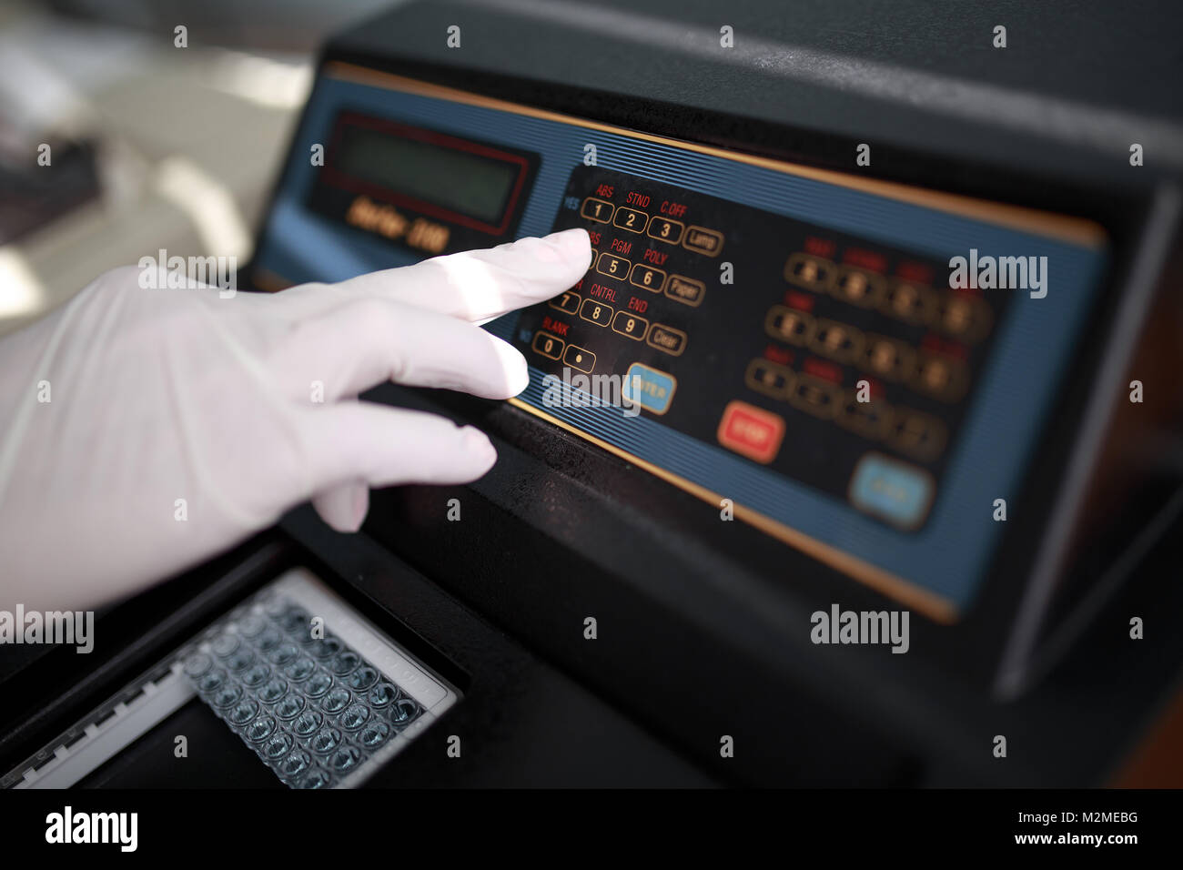 close up of scientist hands with lab testing machine, examining samples ...