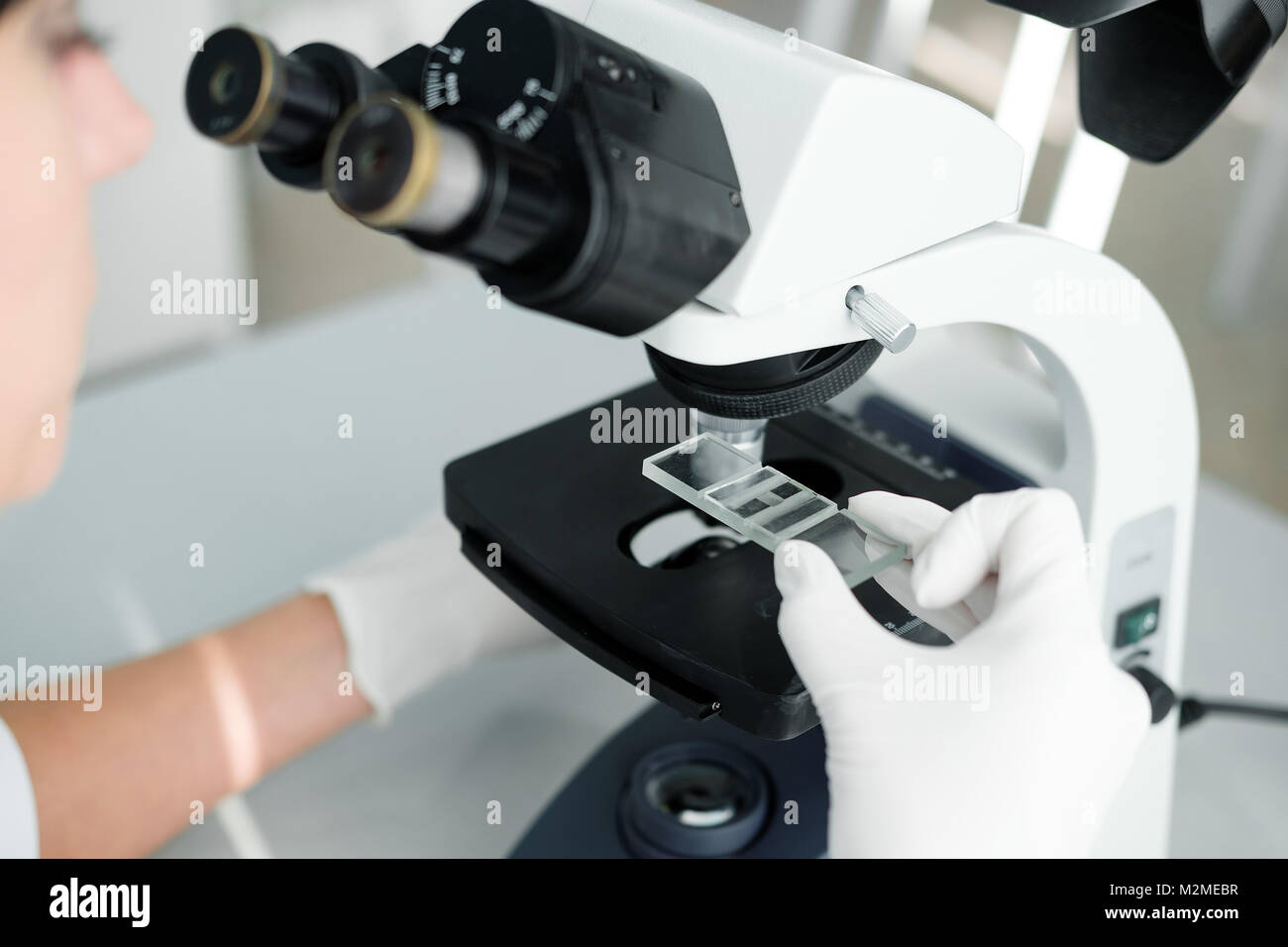 close up of scientist hands with microscope, examining samples in ...