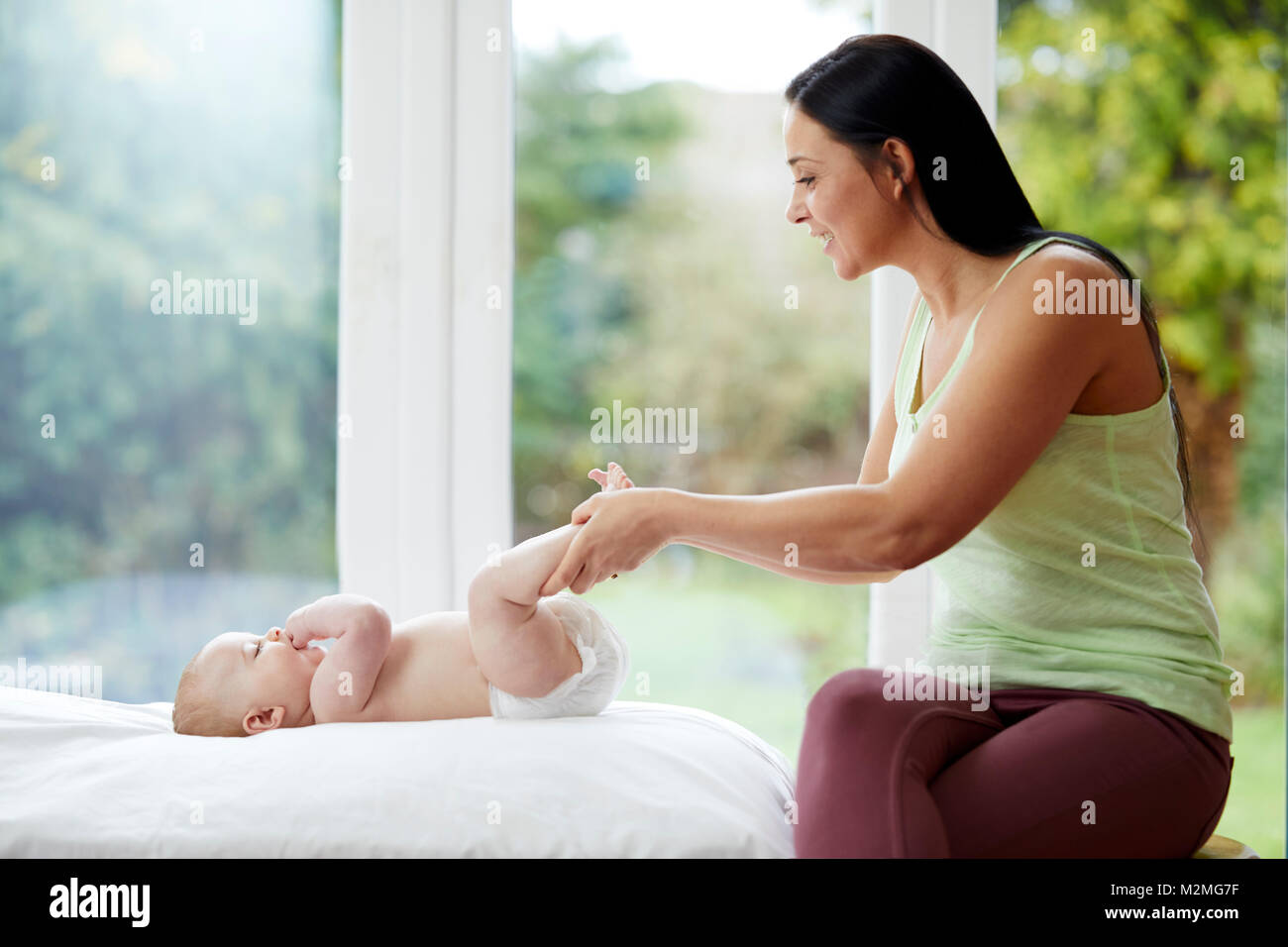 Mother interacting with her baby Stock Photo - Alamy