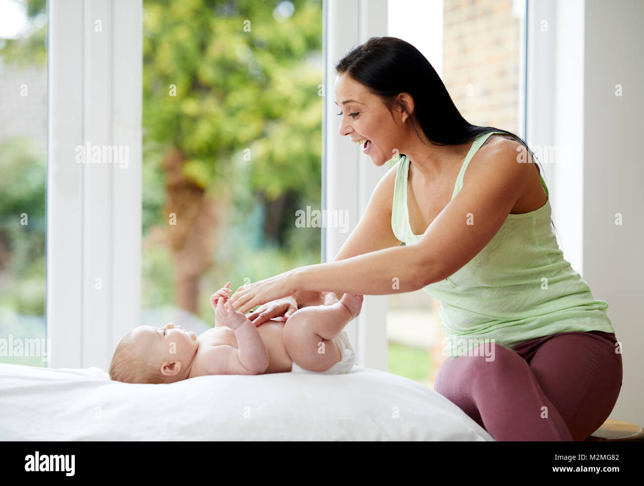 Mother interacting with her baby Stock Photo - Alamy