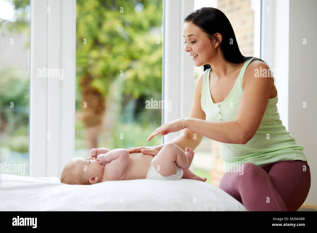 Mother interacting with her baby Stock Photo - Alamy