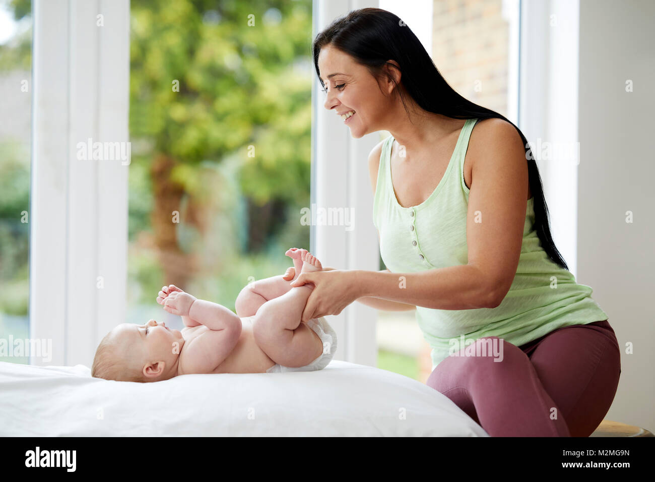 Mother interacting with her baby Stock Photo - Alamy