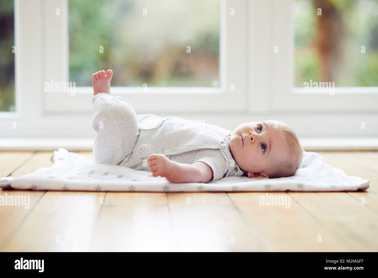 Baby laid on a matt Stock Photo - Alamy