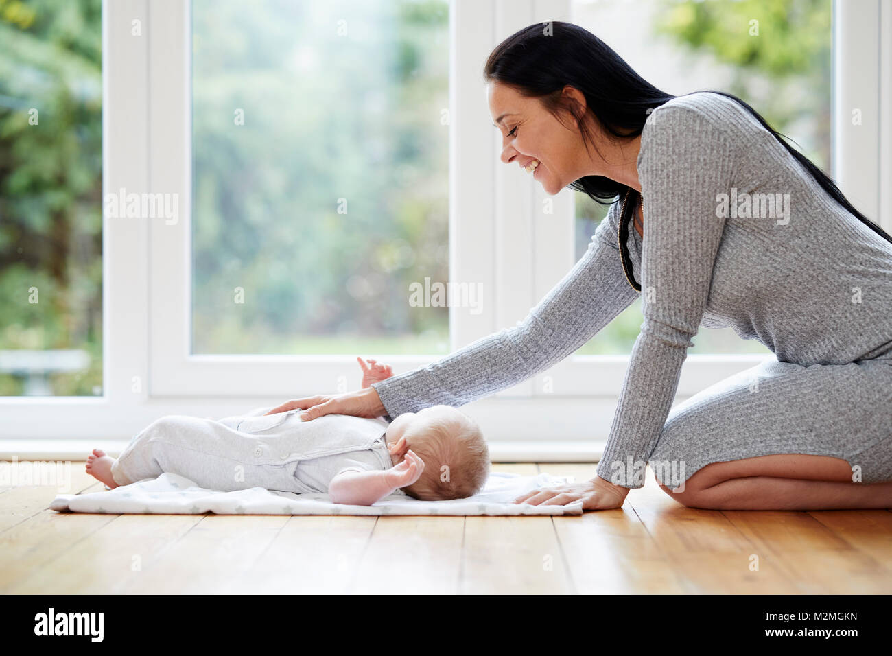 Mother interacting with her baby Stock Photo - Alamy
