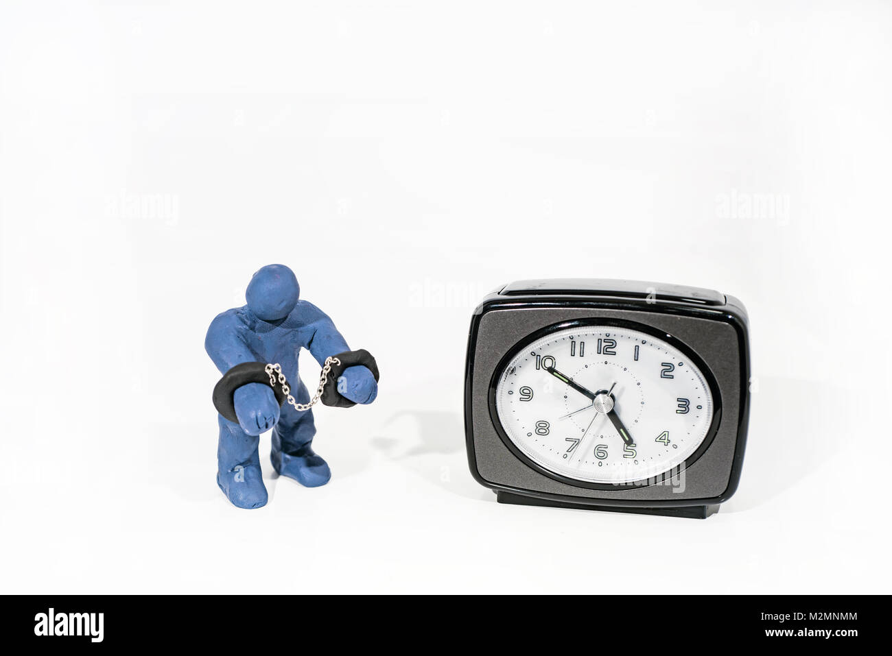 Small blue figure in handcuffs. Made from Play Clay. Isolated on white ...