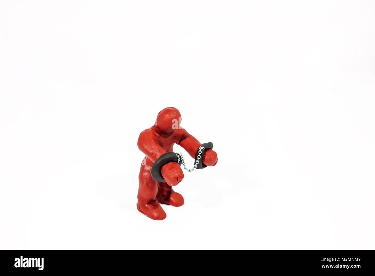 Small red figure in handcuffs. Made from Play Clay. Isolated on white ...