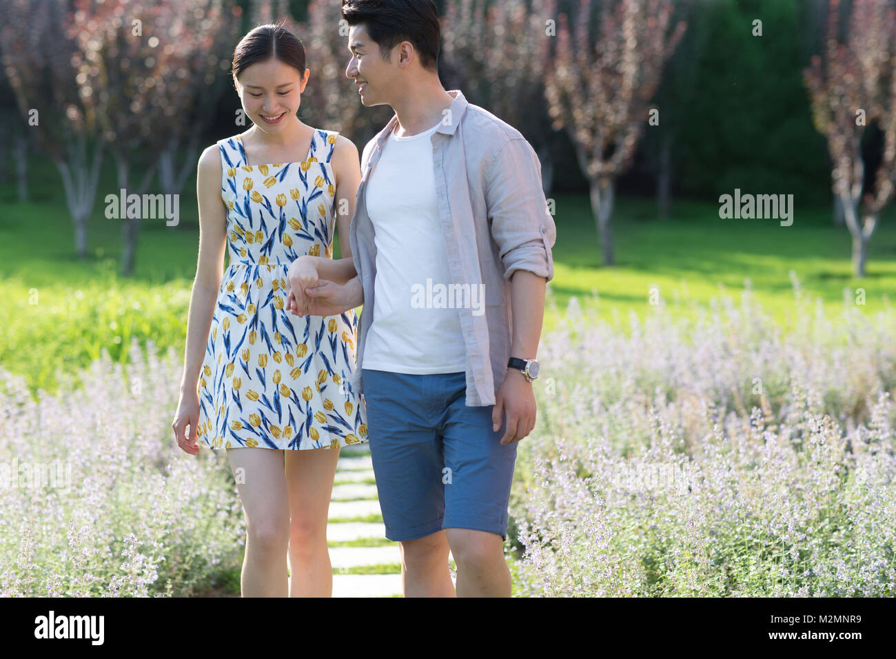 Romantic lovers walking in the park Stock Photo - Alamy